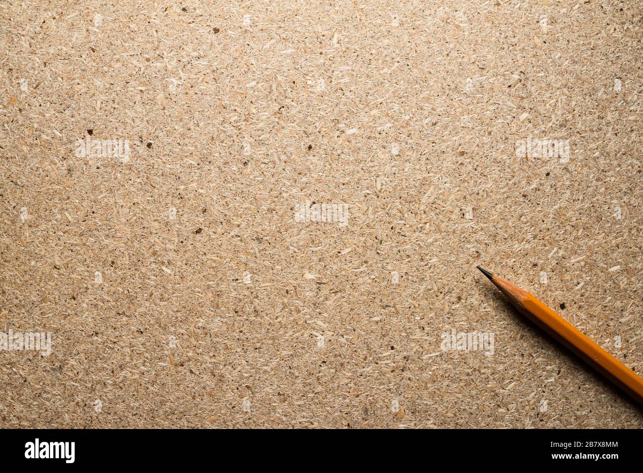 Pencil on a chipboard board. Top view Stock Photo - Alamy