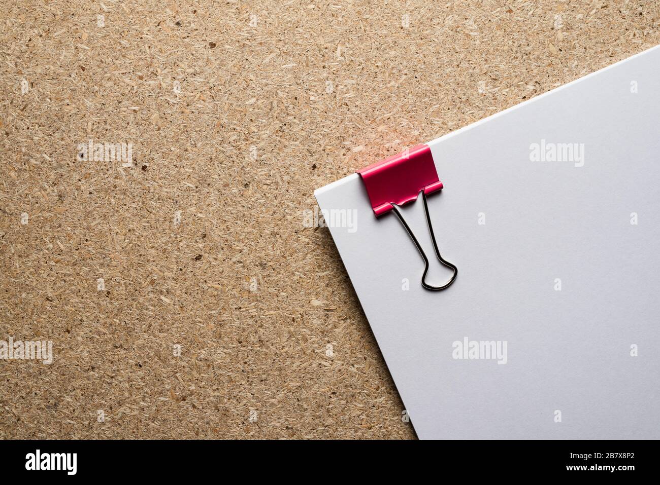 A stack of paper sheets with clip on chipboard table Stock Photo - Alamy