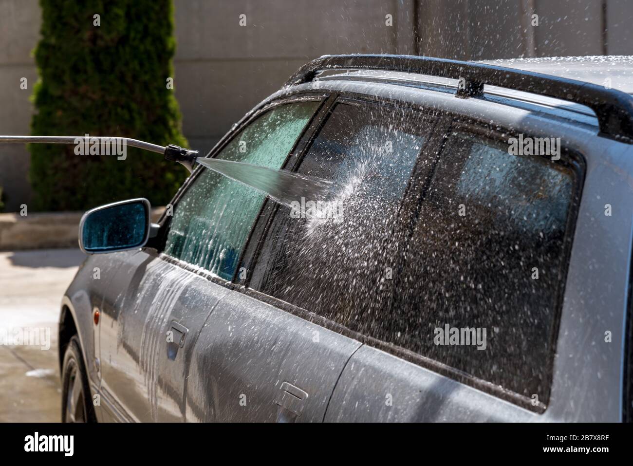 Car washing with flowing water. Outdoor Self Service Cleaning Car Using ...