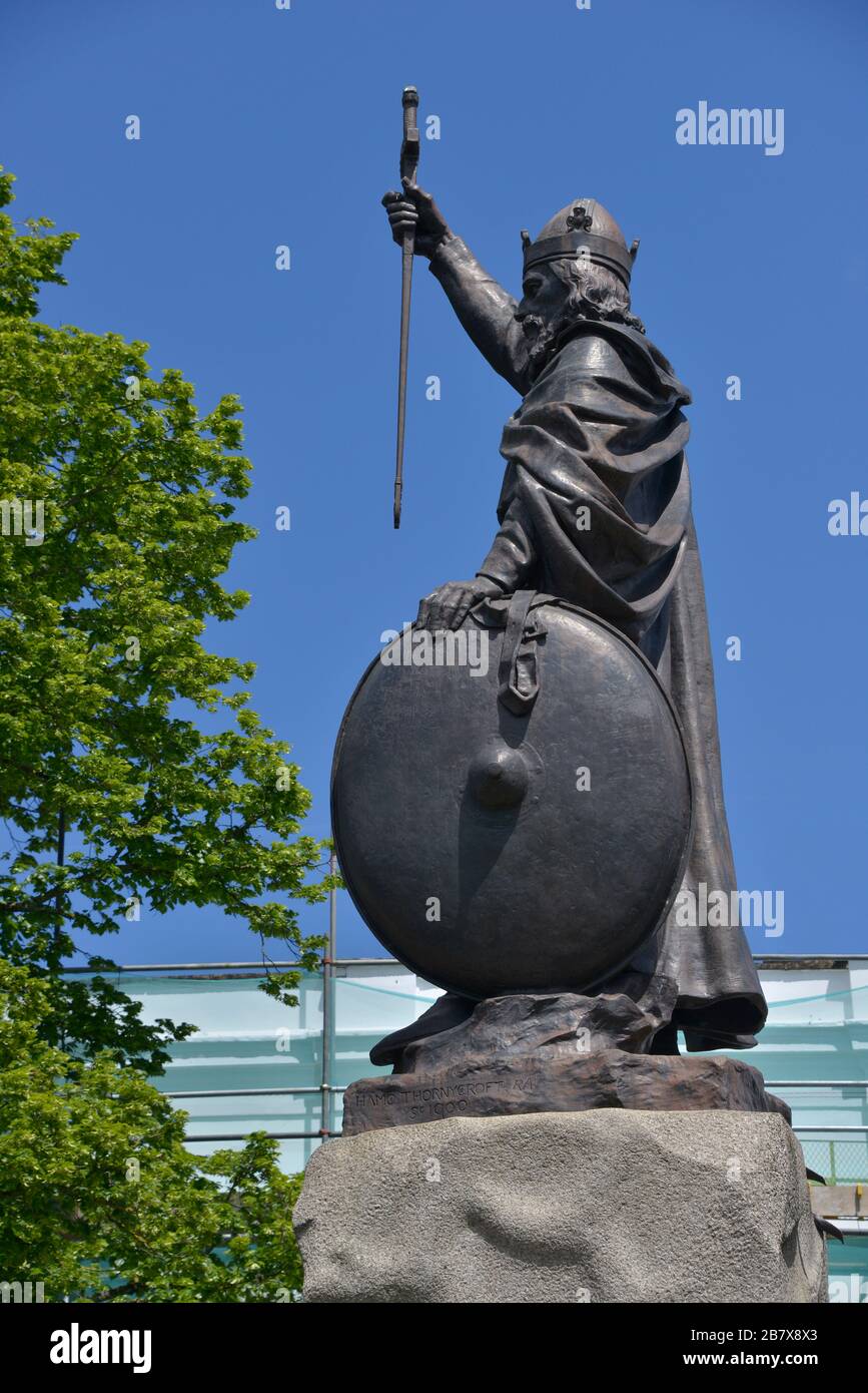 Statue of King Alfred the Great standing in historic Winchester against ...