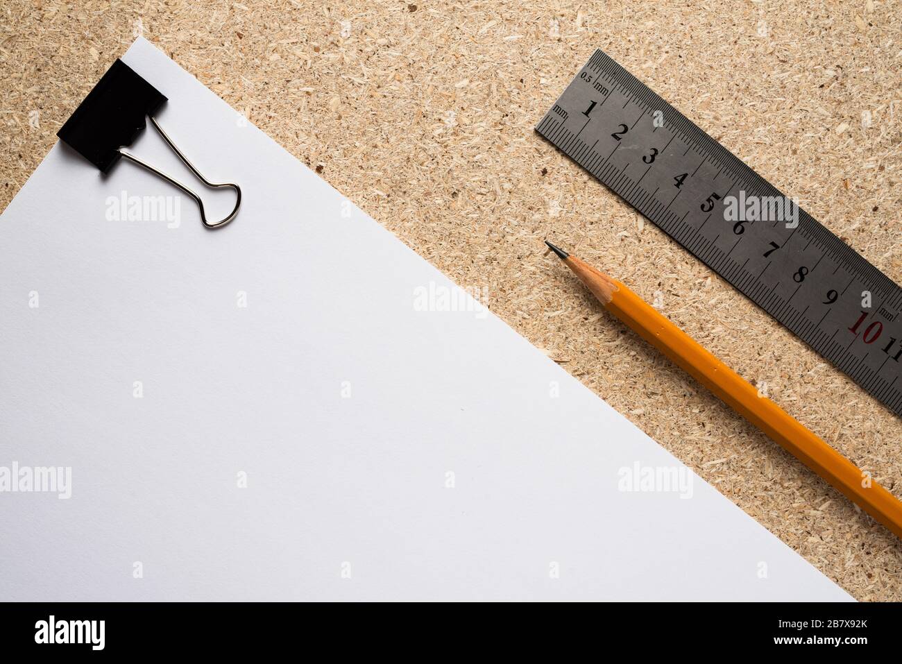 Paper form, ruler and pencil on a chipboard table Stock Photo - Alamy