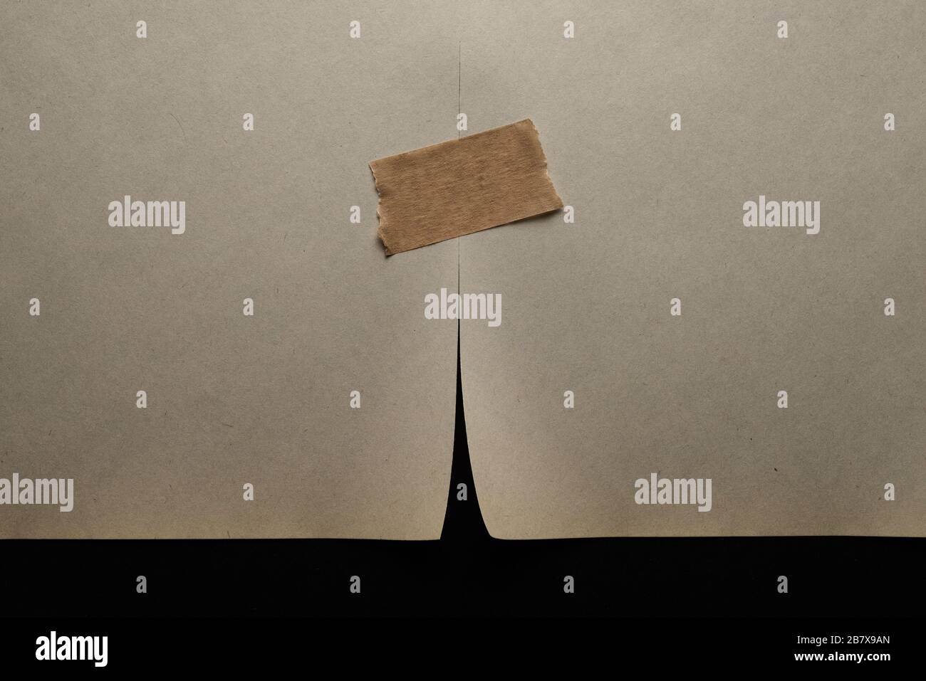 A neat cut of a brown sheet of paper taped Stock Photo - Alamy