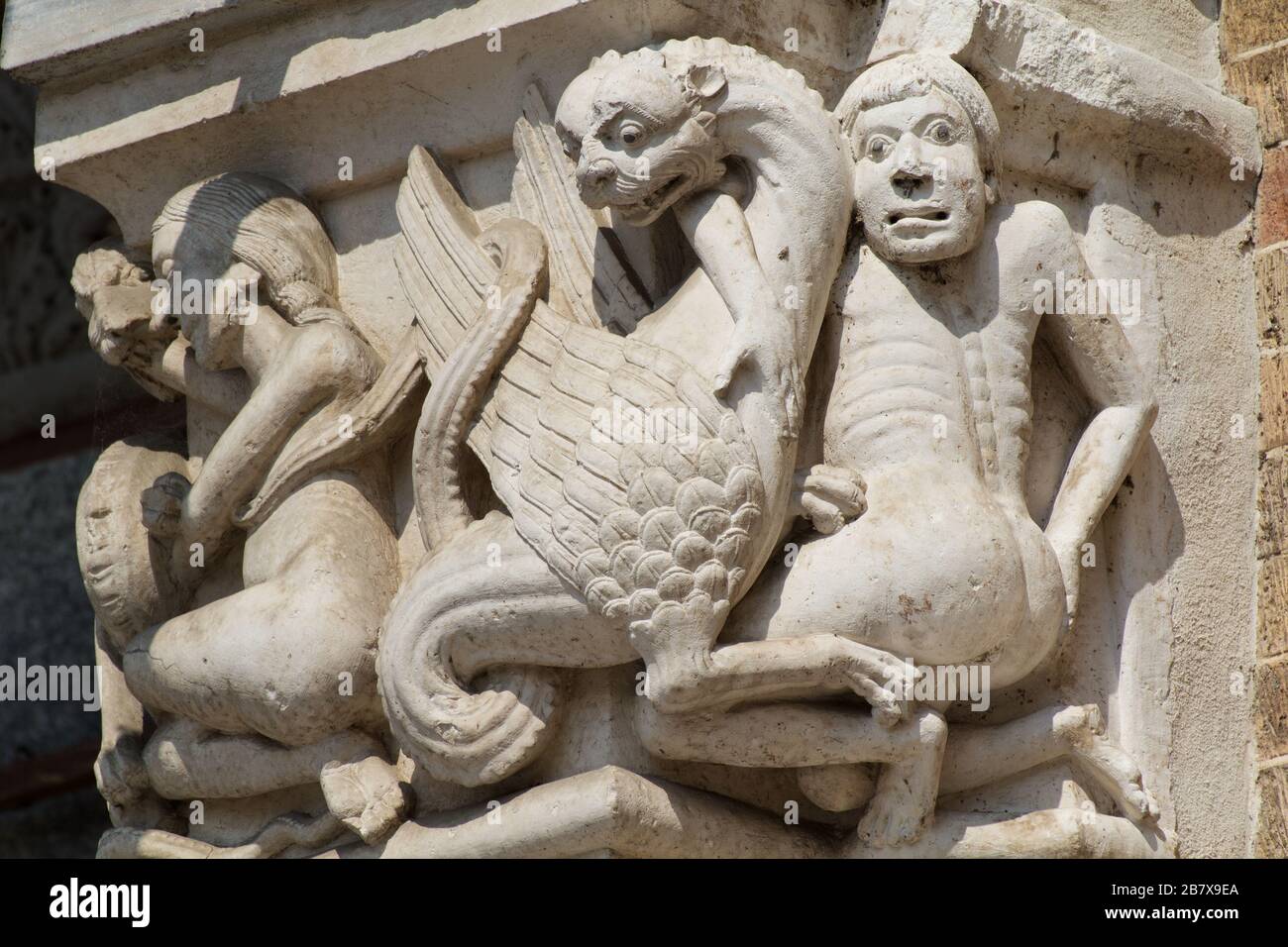 A mythological animal tickles the intimate parts of a naked figure with ...