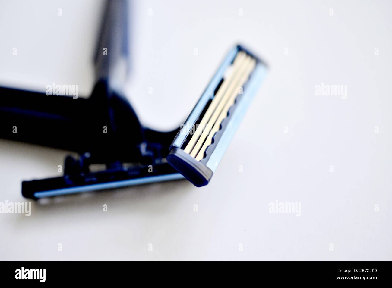 new blue blade razor on white background image Stock Photo - Alamy