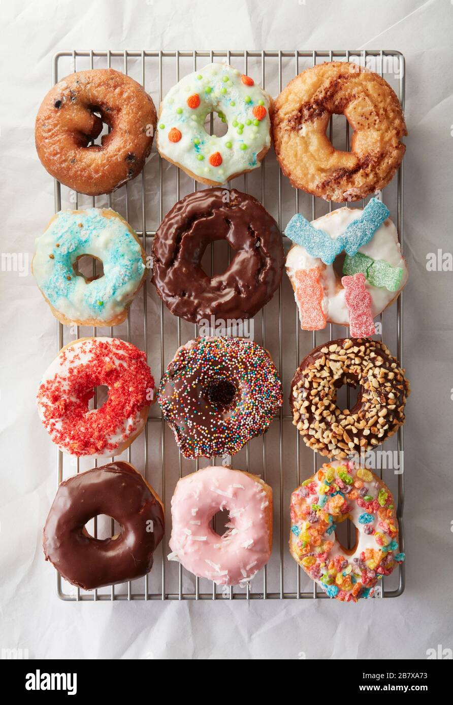 Dozen Colorful Donuts Freshly Baked and Decorated Stock Photo - Alamy