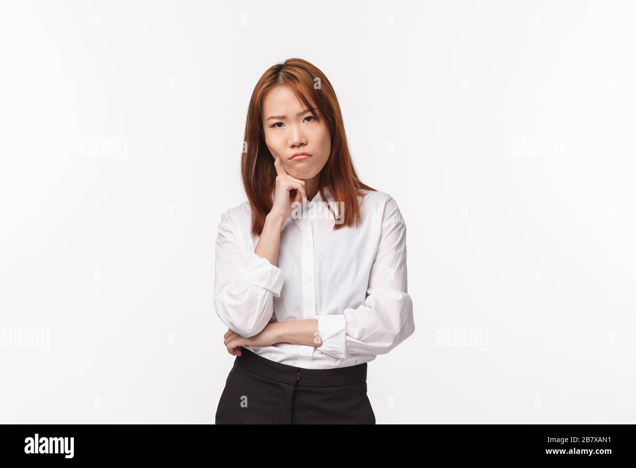 Thoughtful and serious grumpy young asian woman thinking, having ...