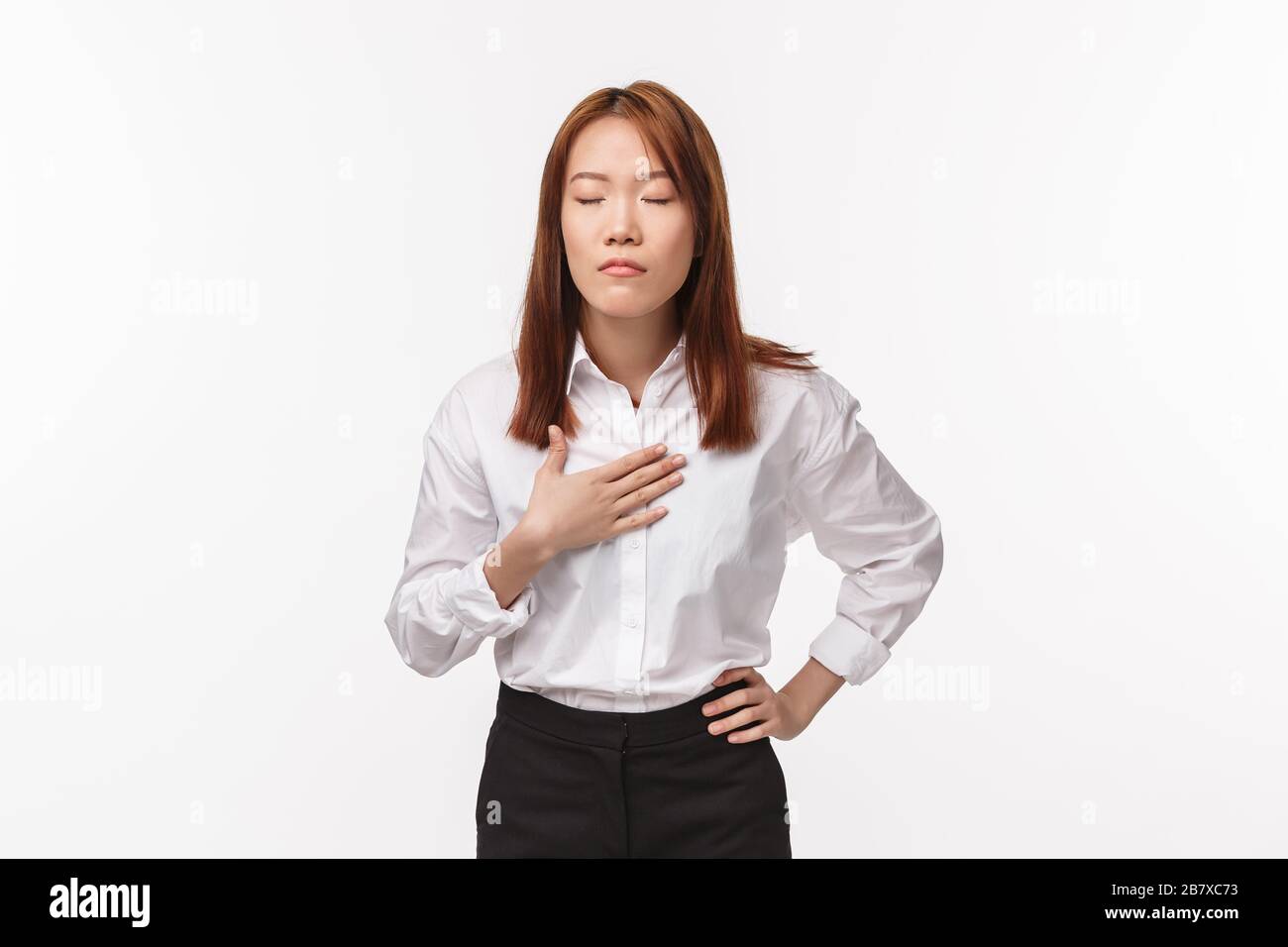 Relieved and chill-out asian woman trying breath and be calm, touch ...