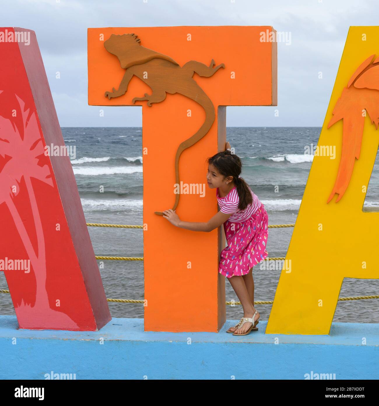 Girl playing around alphabet signs, Flowers Bay, Roatan, Honduras Stock ...