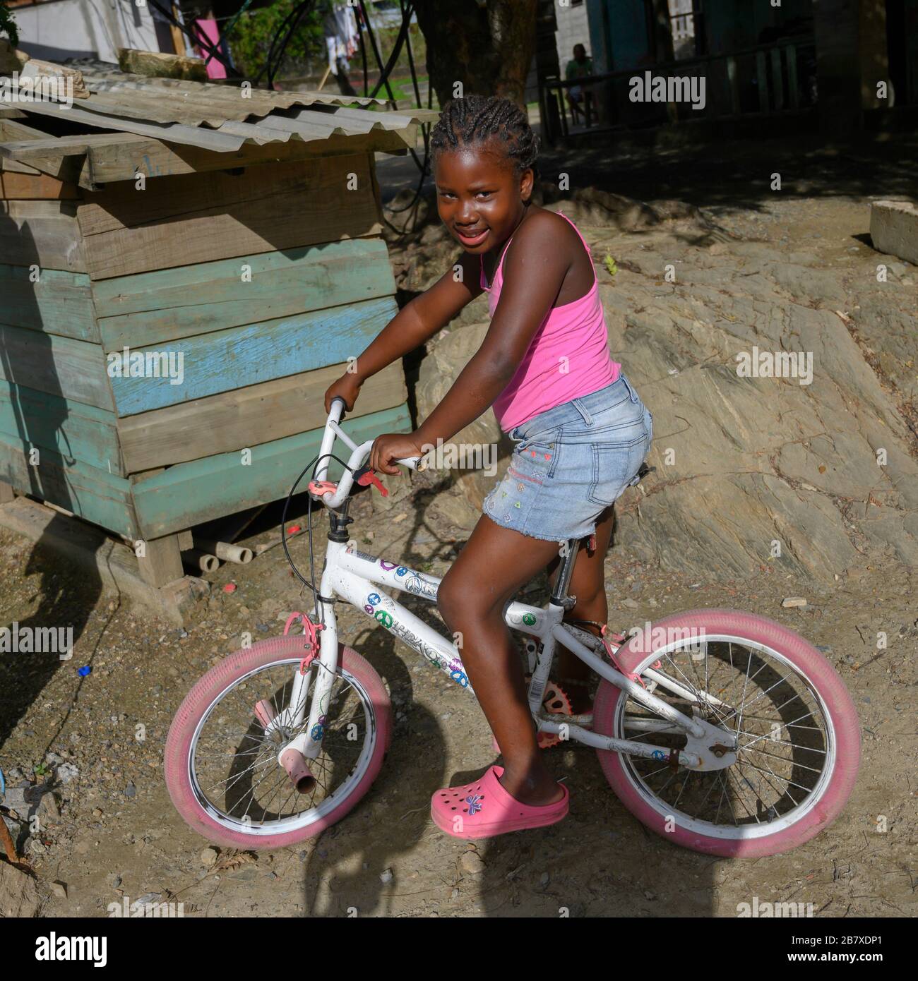 Young girl riding a bicycle, Los Fuertes, Roatan, Honduras Stock Photo ...