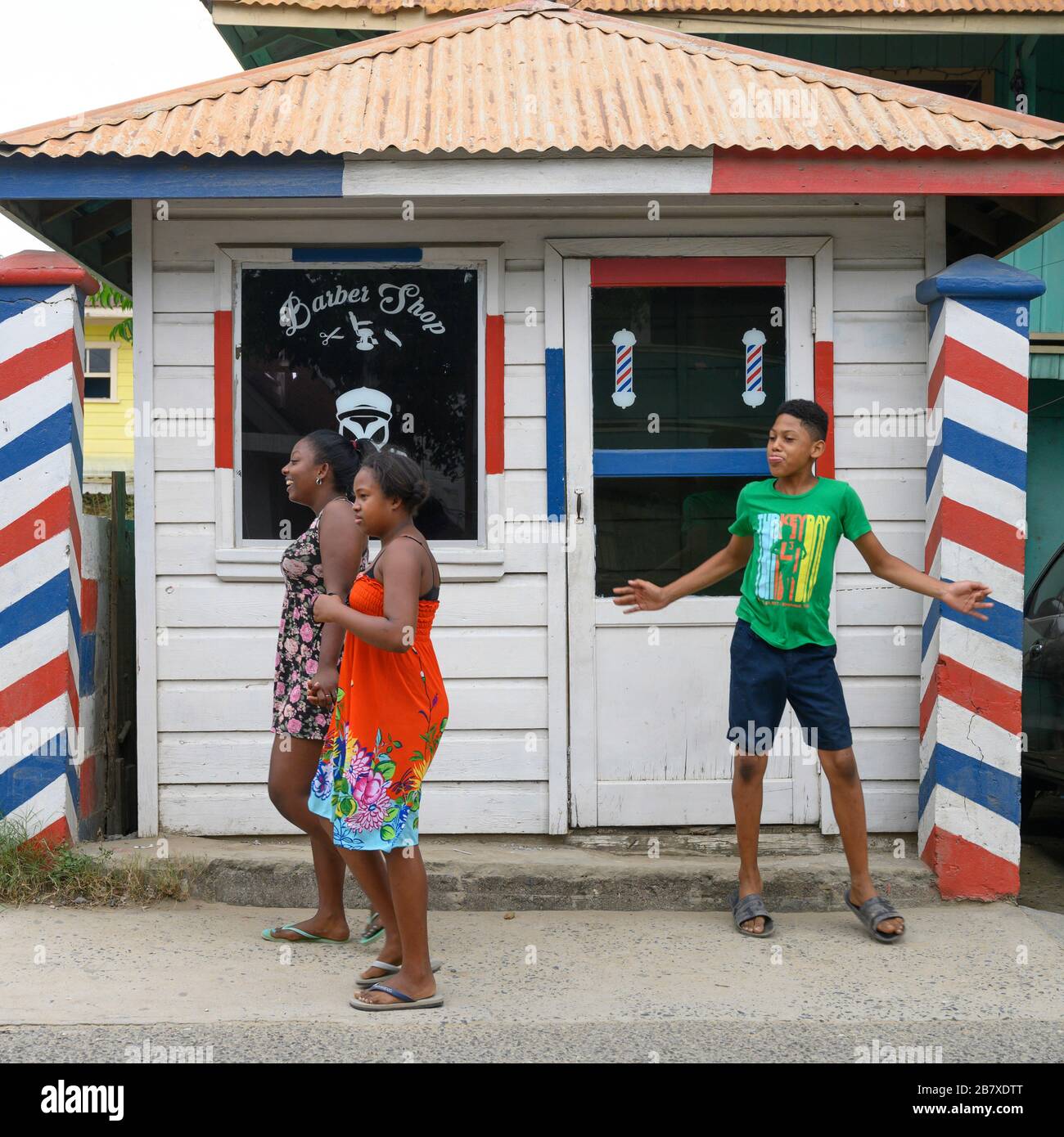 People outside a barber shop, Coxen Hole, Gravel Bay, Roatan, Honduras ...