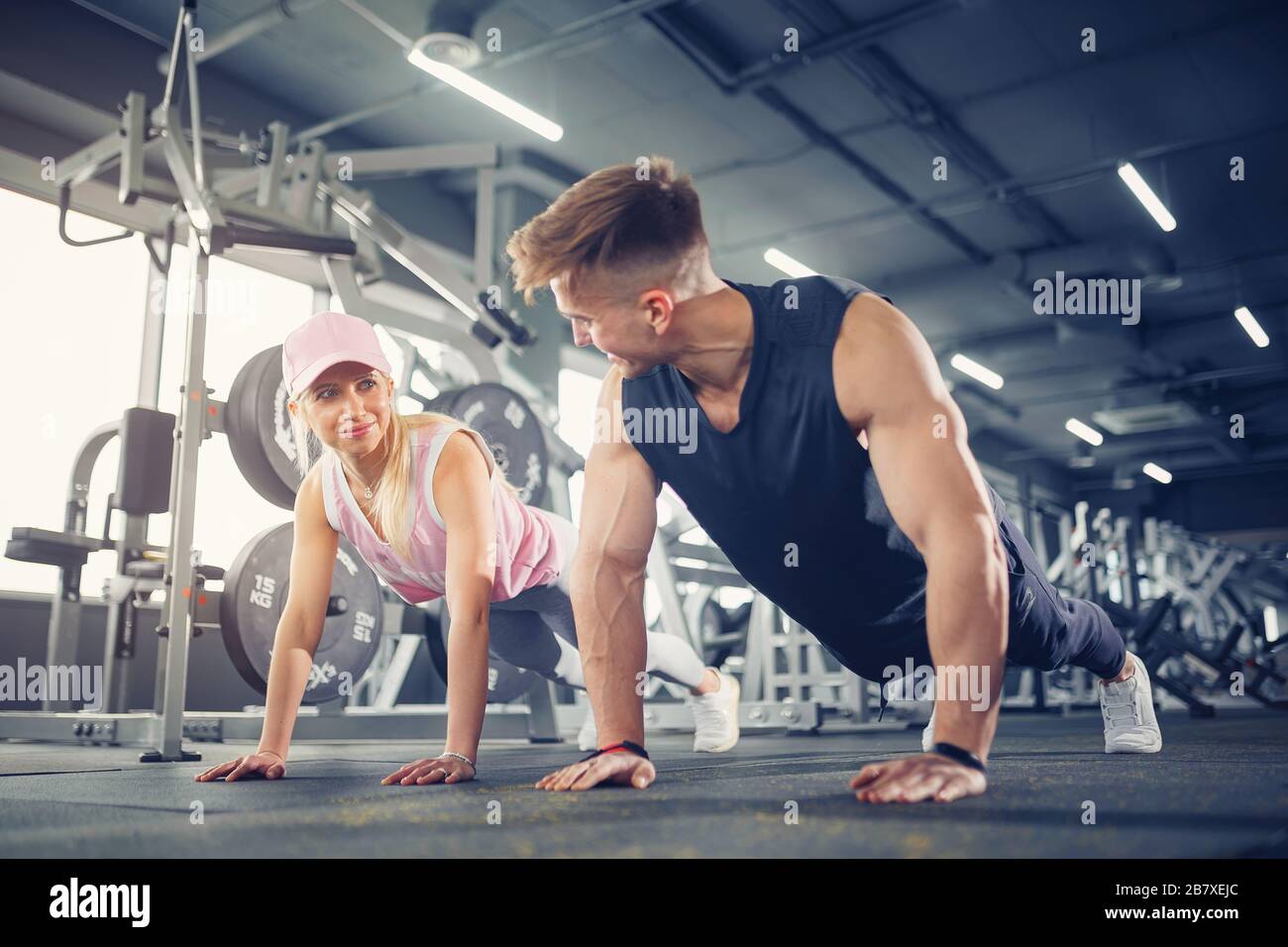 Man and woman strengthen hands at fitness training. Fitness young ...