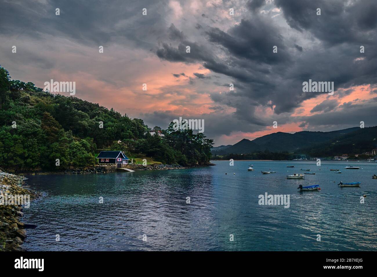 sunset with views of a cabin near the water Stock Photo - Alamy