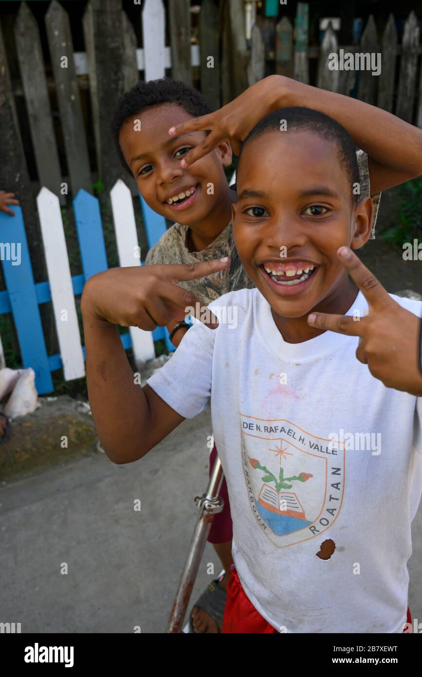 Happy adolescent boys making hand gestures, Los Fuertes, Roatan ...