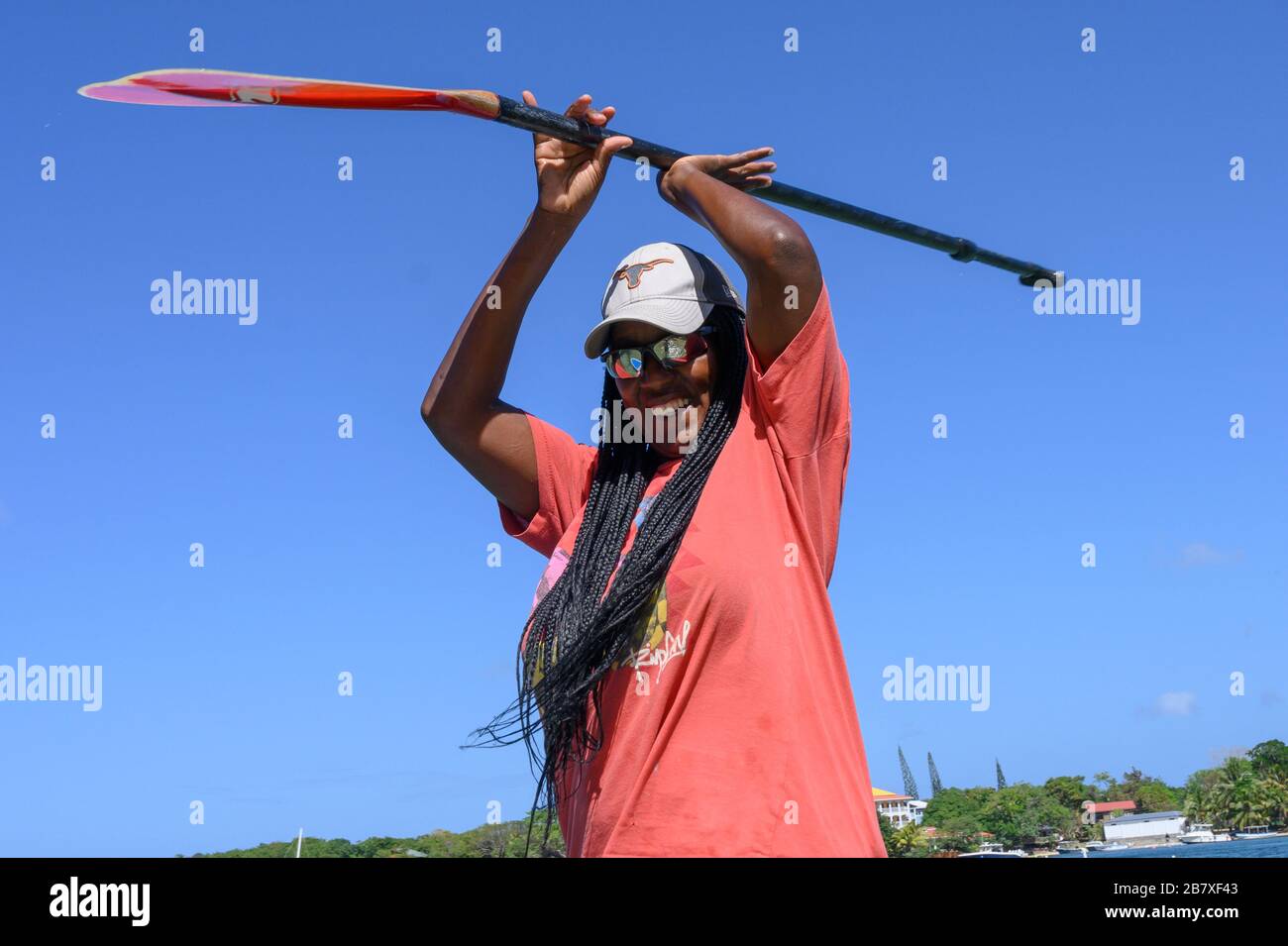 Happy woman holding up oar, West End Village, Roatan, Honduras Stock ...