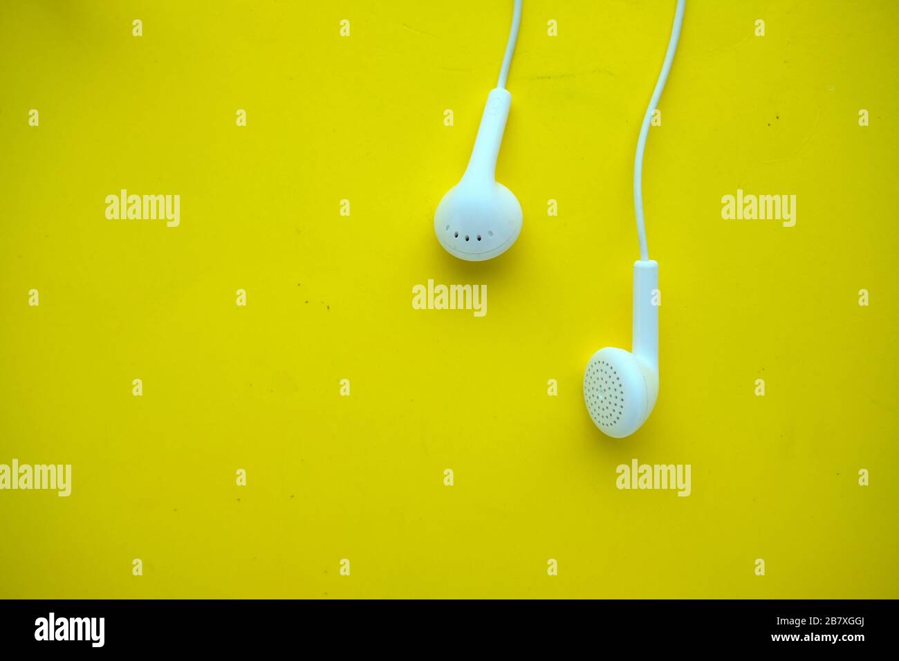 Earphones headset on yellow background , top view Stock Photo - Alamy