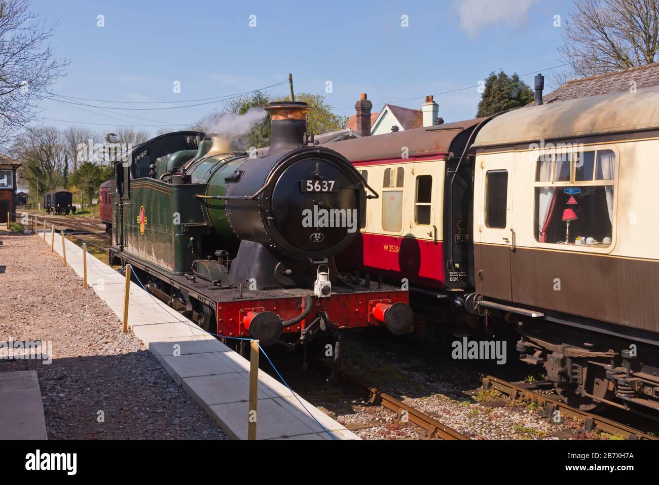 5600 Class steam locomotive 5637 shunting past a line of carriages at ...