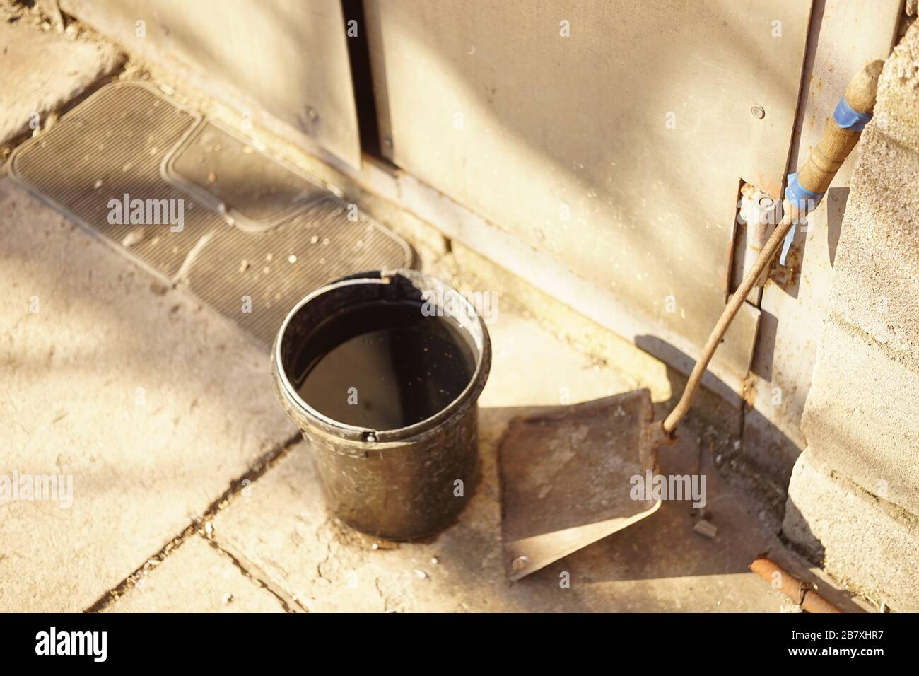 Old scoop and bucket of water at the rural threshold on a sunny day ...