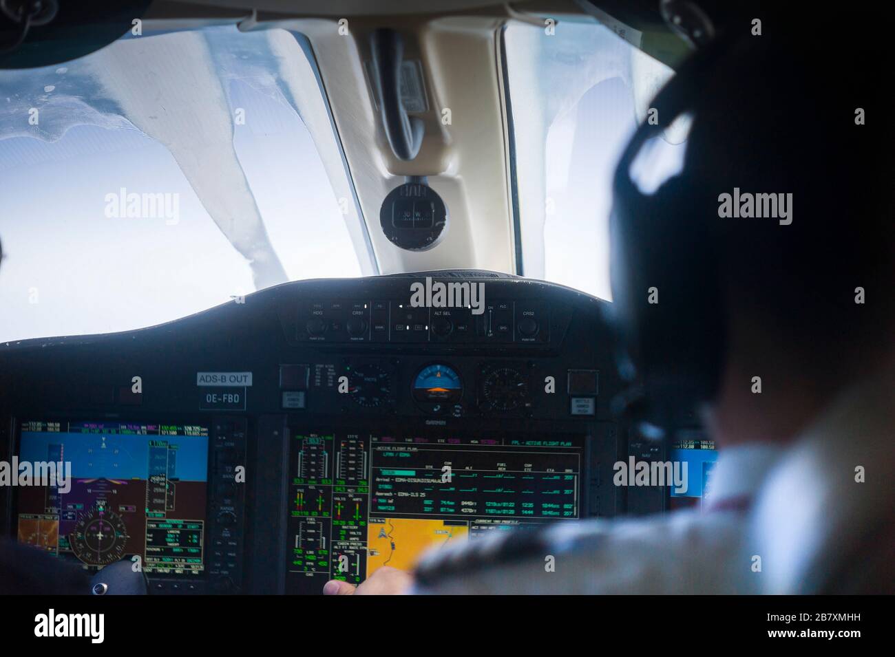 Frozen plane windshield and a pilot in the blurred foreground Stock ...