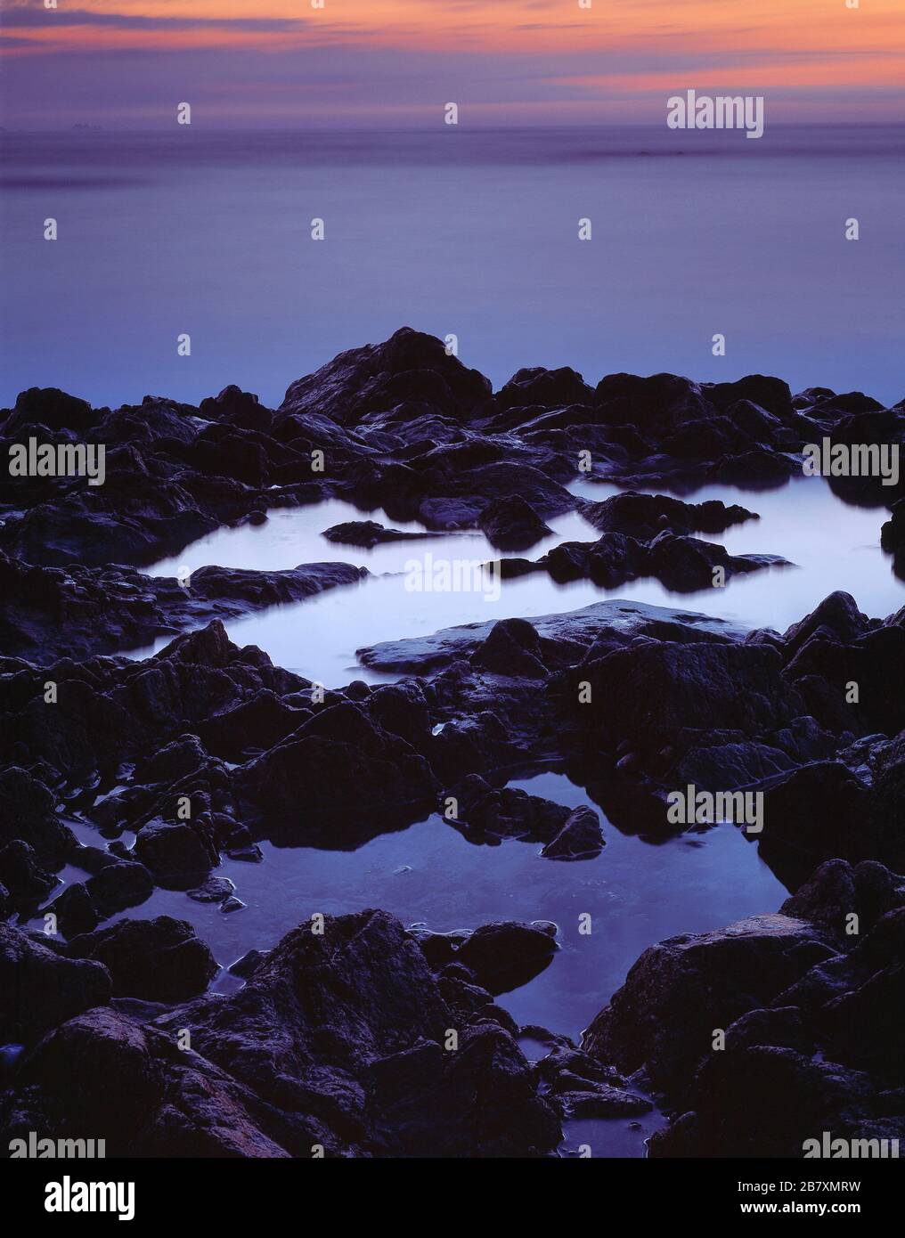 Guernsey. Coastal rock pools at sunset Stock Photo - Alamy