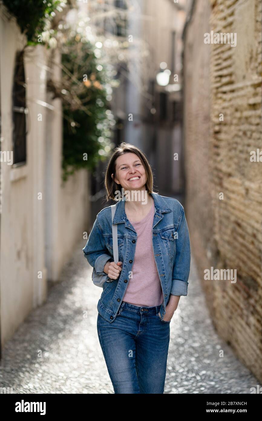 Beautiful happy girl walking on the street Stock Photo - Alamy