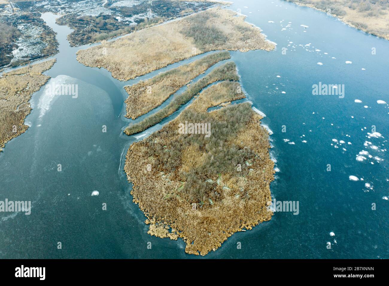 An island with reeds in the middle of a river. The island is similar to ...