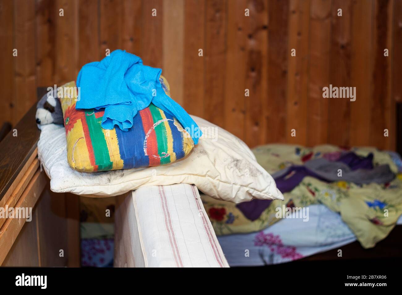 Disassembled bed wih a heap of crumpled clothing, indoor shot Stock ...
