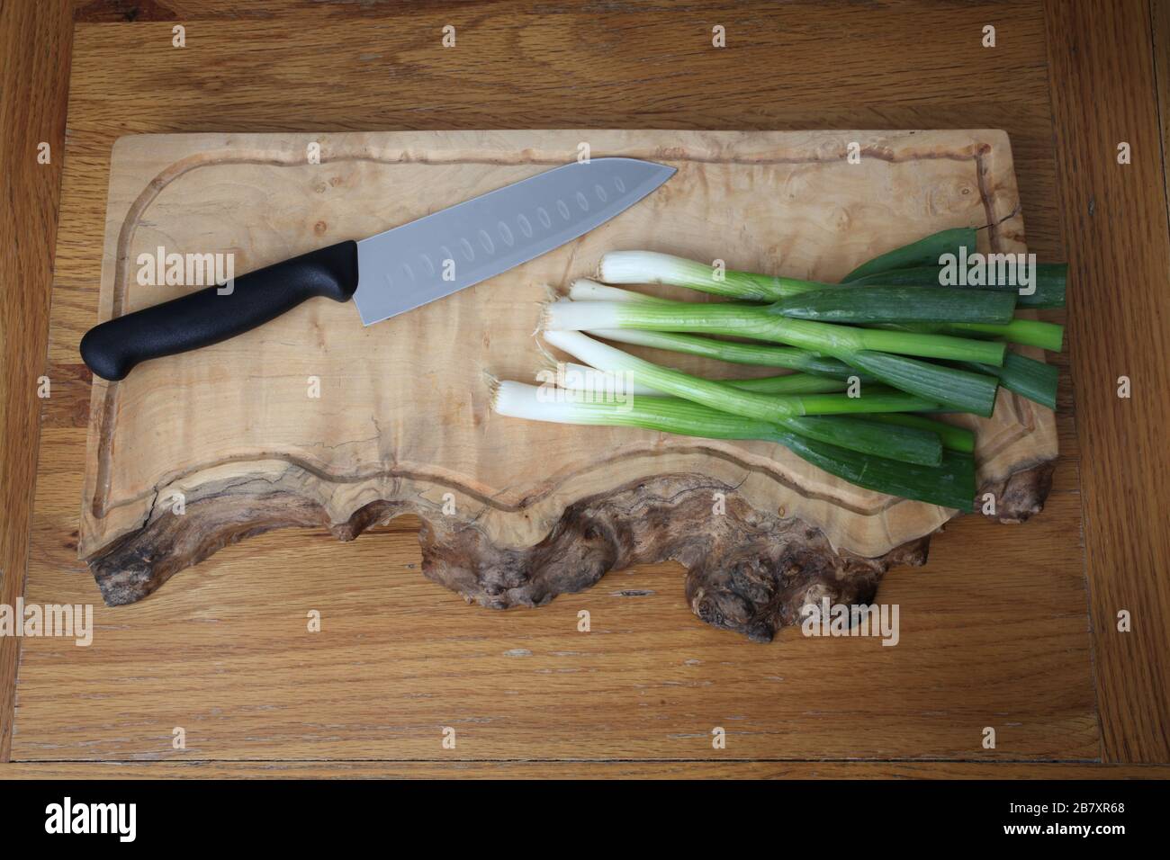 A studio photograph of spring onions on a chopping board Stock Photo ...