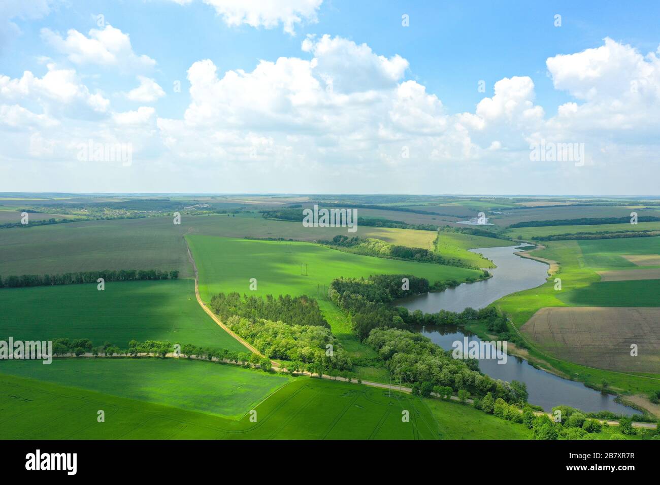 Spring nature in Ukraine. Green fields and meadows, white clouds and ...