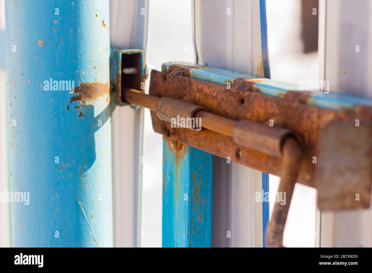 Rusty old slide bolt or tower bolt on a worn green door Stock Photo - Alamy
