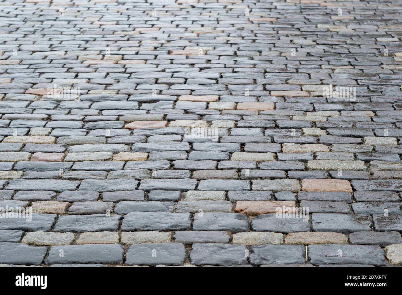 Ancient paving stones made of rectangular stone bricks. Textured ...