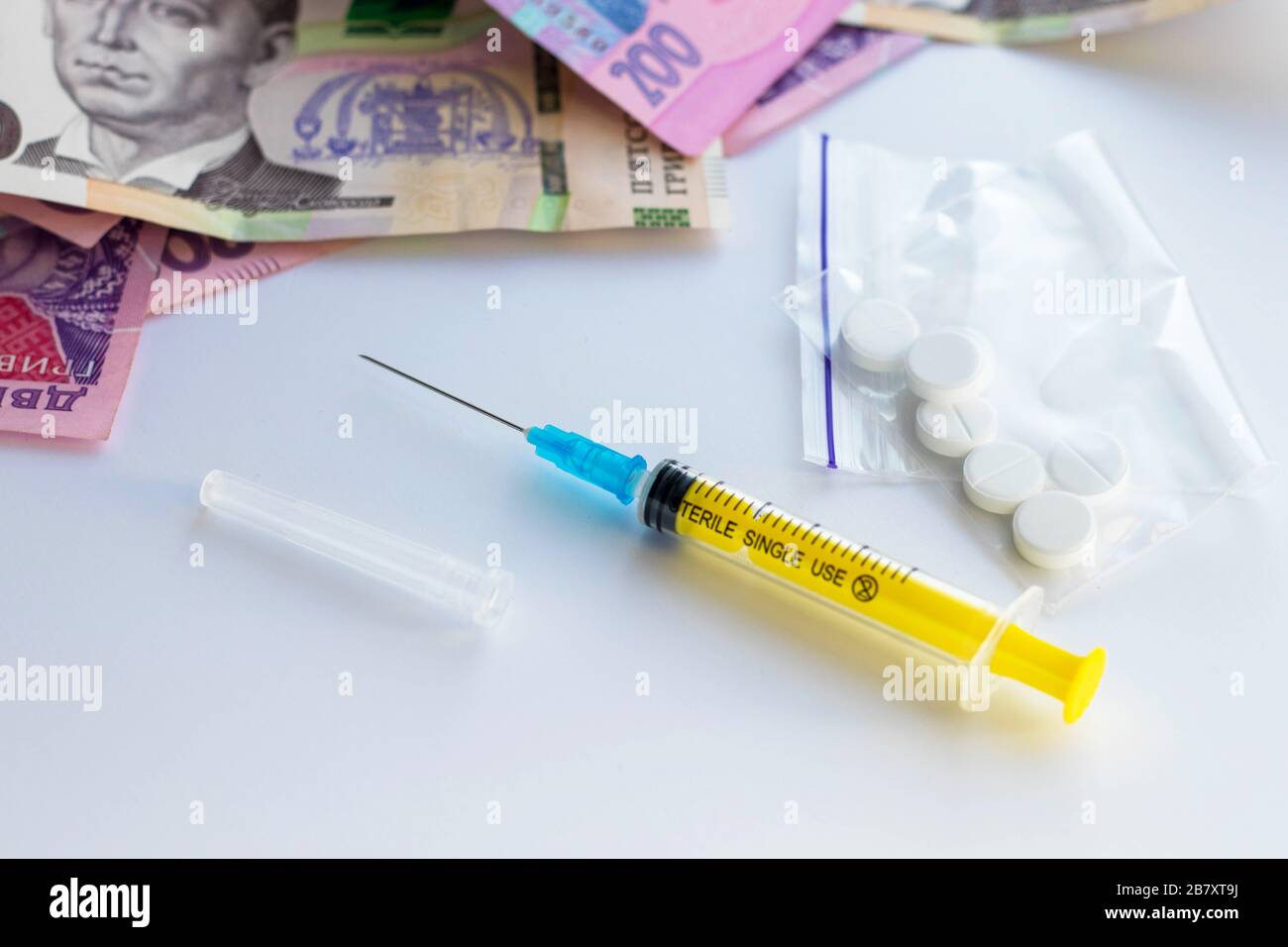 Syringe, pills in zip lock plastic bag and lot ukrainian money. Sale of ...