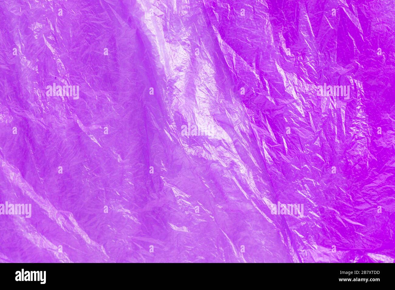 Close up texture of bright purple plastic garbage bag. Crumpled ...