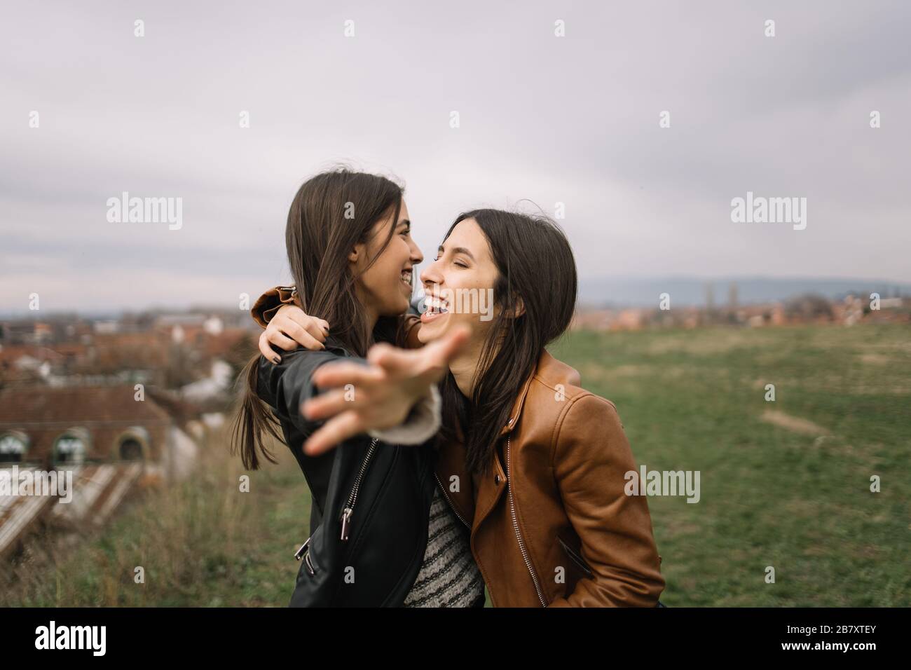 Beautiful girls hugging in the spring park Stock Photo - Alamy