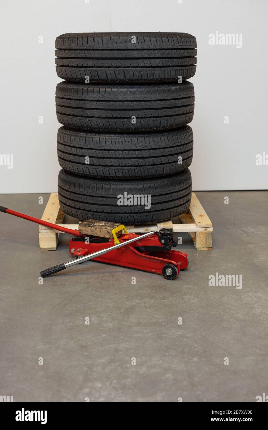 Close up car tyres on wheels storage on a pallet and tire replacement ...