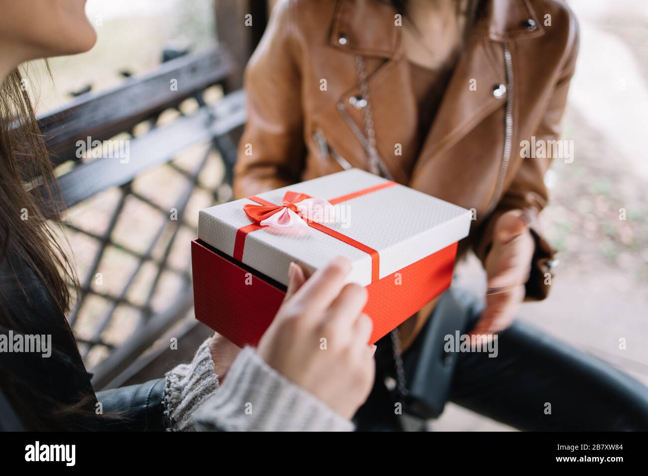 Female hands receiving and opening a present outdoors Stock Photo - Alamy