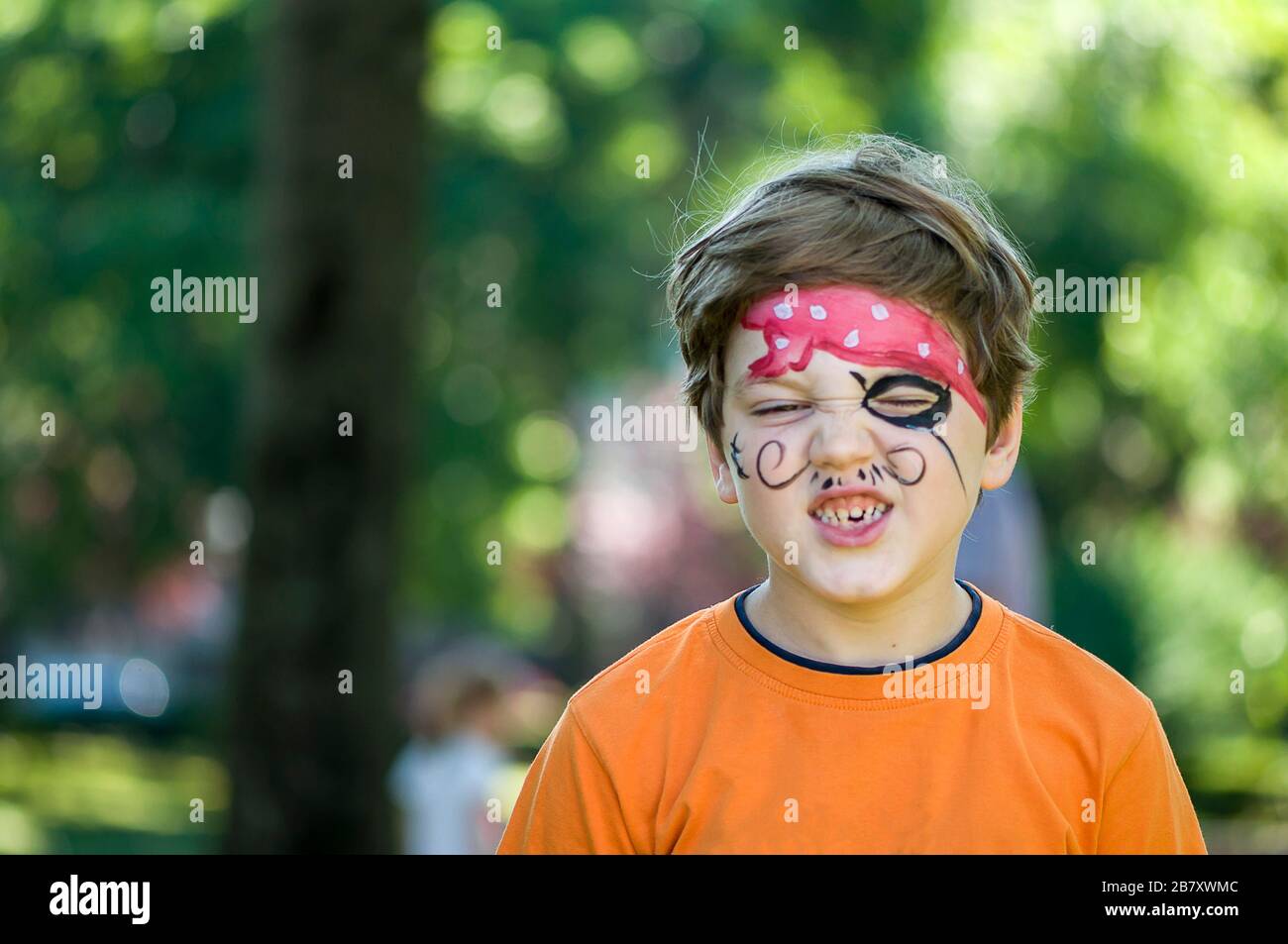 Child making funny faces. Kid with a pirate painting on his face Stock ...