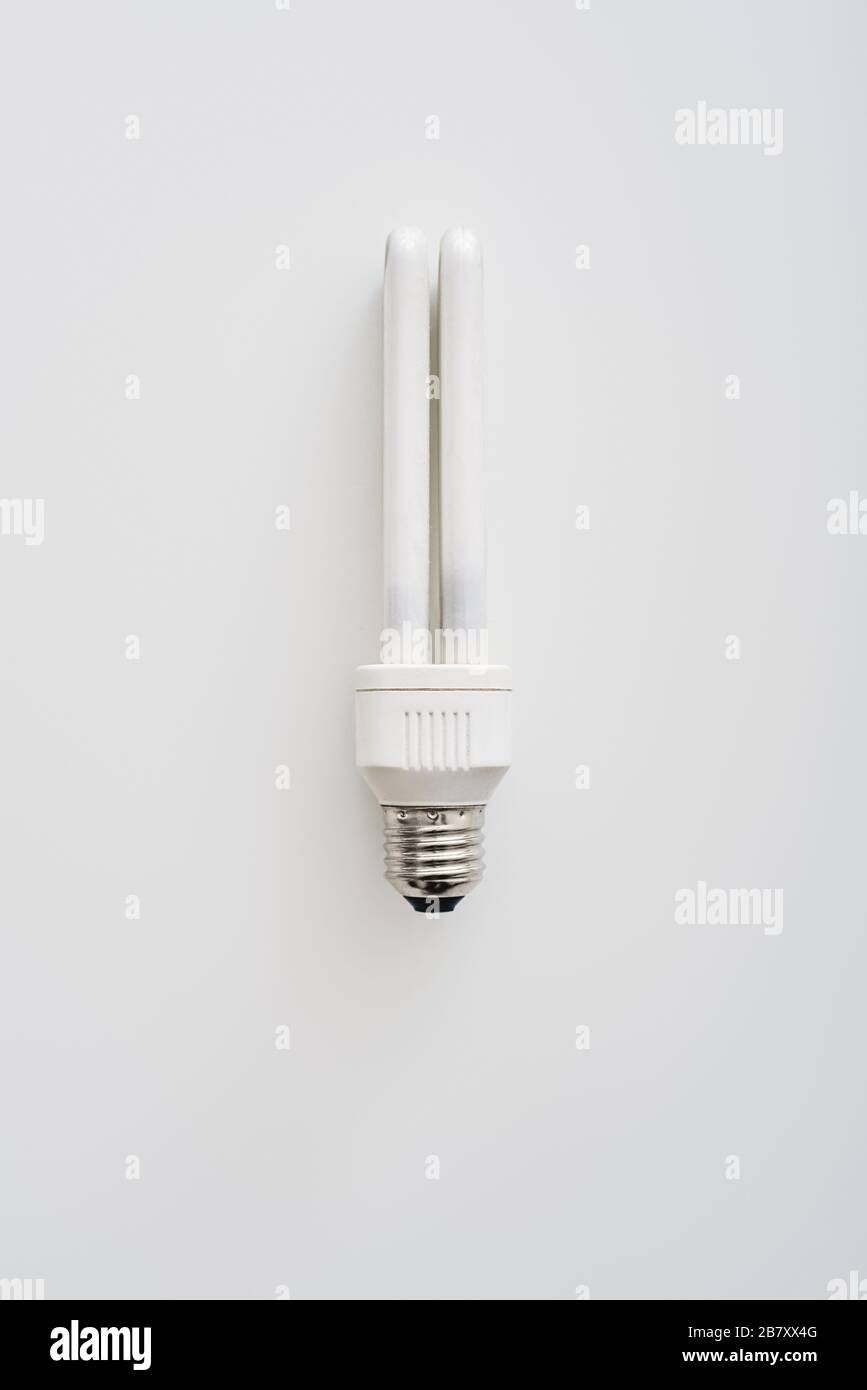 Energy saving light bulb lying vertically isolated on white background ...