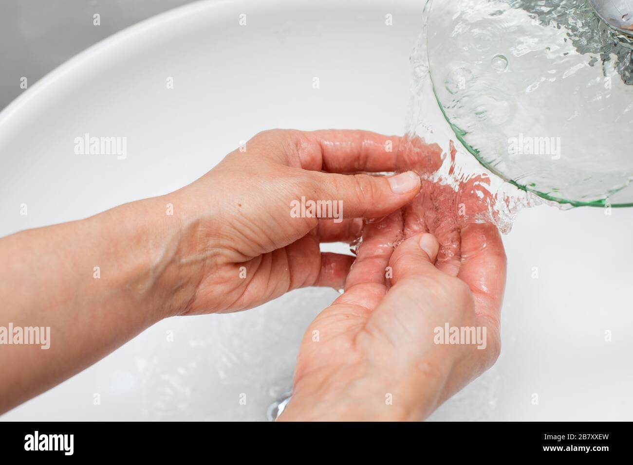 washing hands under a tap with water Stock Photo - Alamy