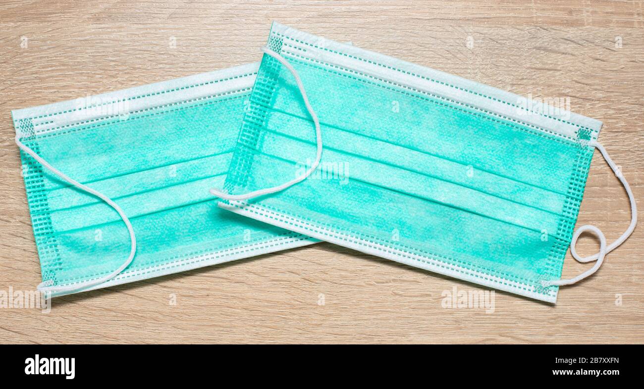 close-up of disposable surgical masks on a wooden background Stock ...