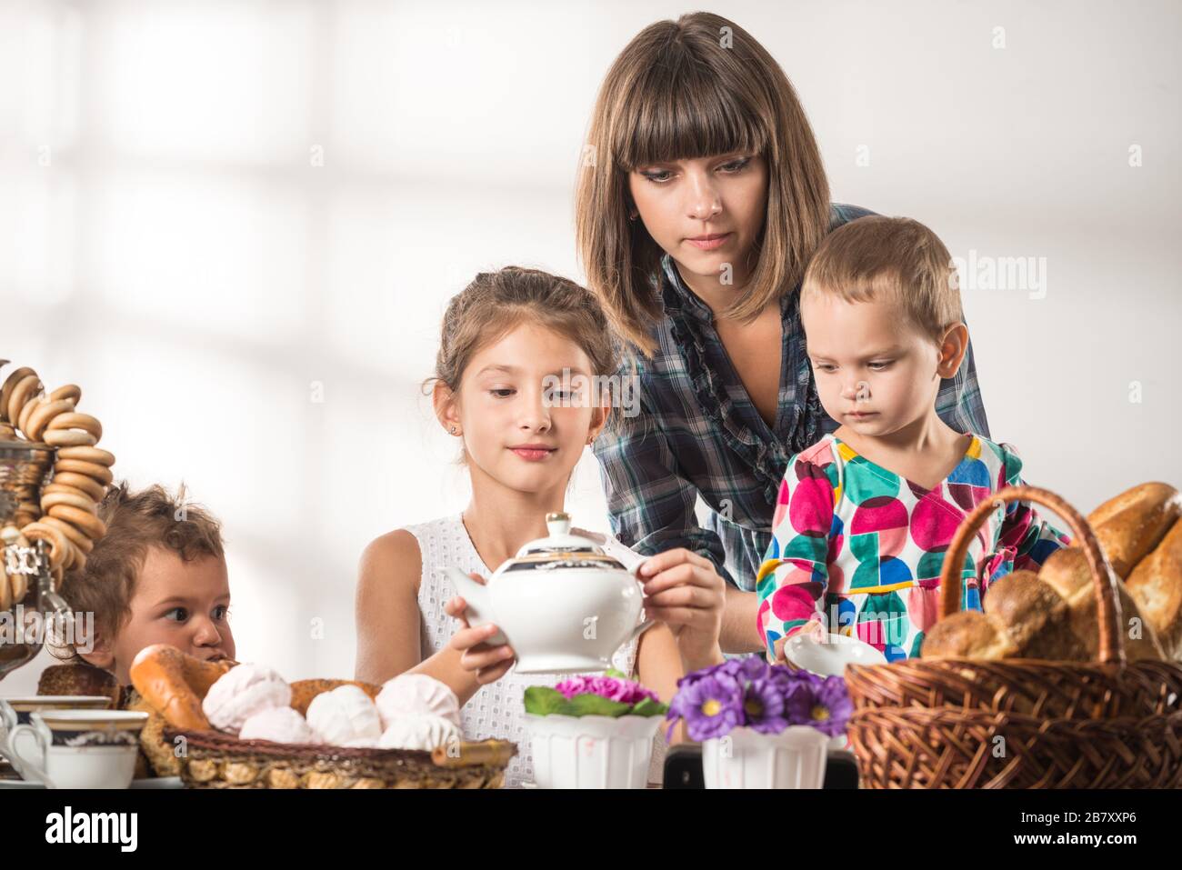 Charming Young Woman Sets The Table For Children During A Children S