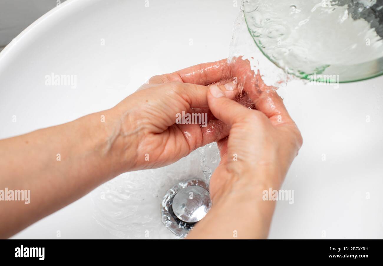 washing hands under a tap with water Stock Photo - Alamy
