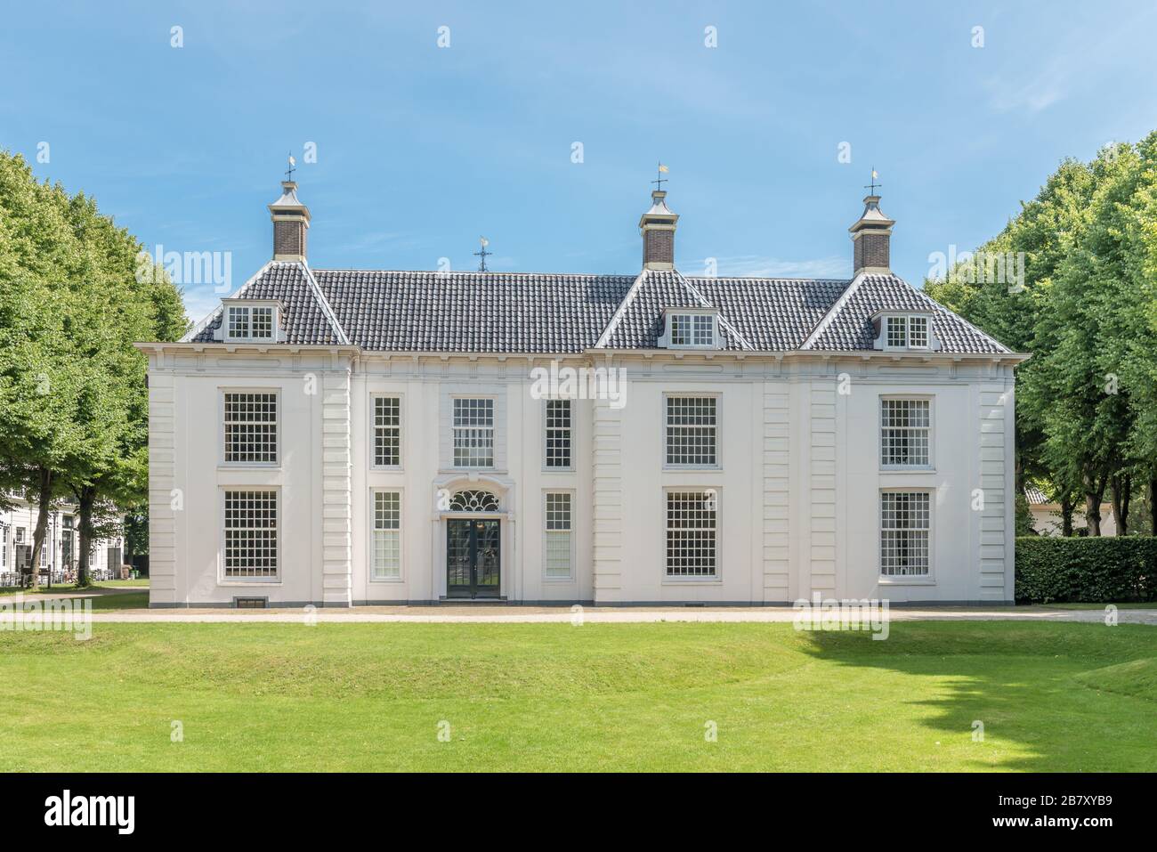 Historic Dutch mansion surrounded by trees and with a blue sky Stock ...