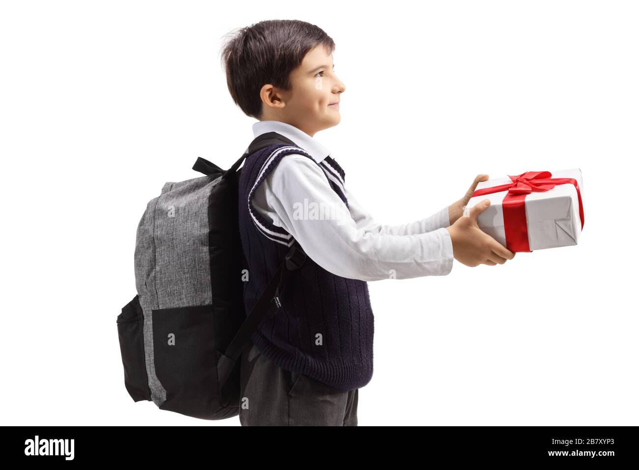 Schoolboy giving a present isolated on white background Stock Photo - Alamy
