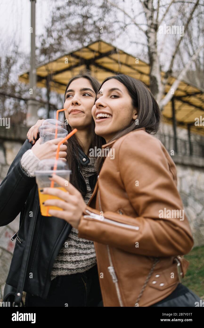 Portrait of two girls drinking fresh outdoors Stock Photo - Alamy