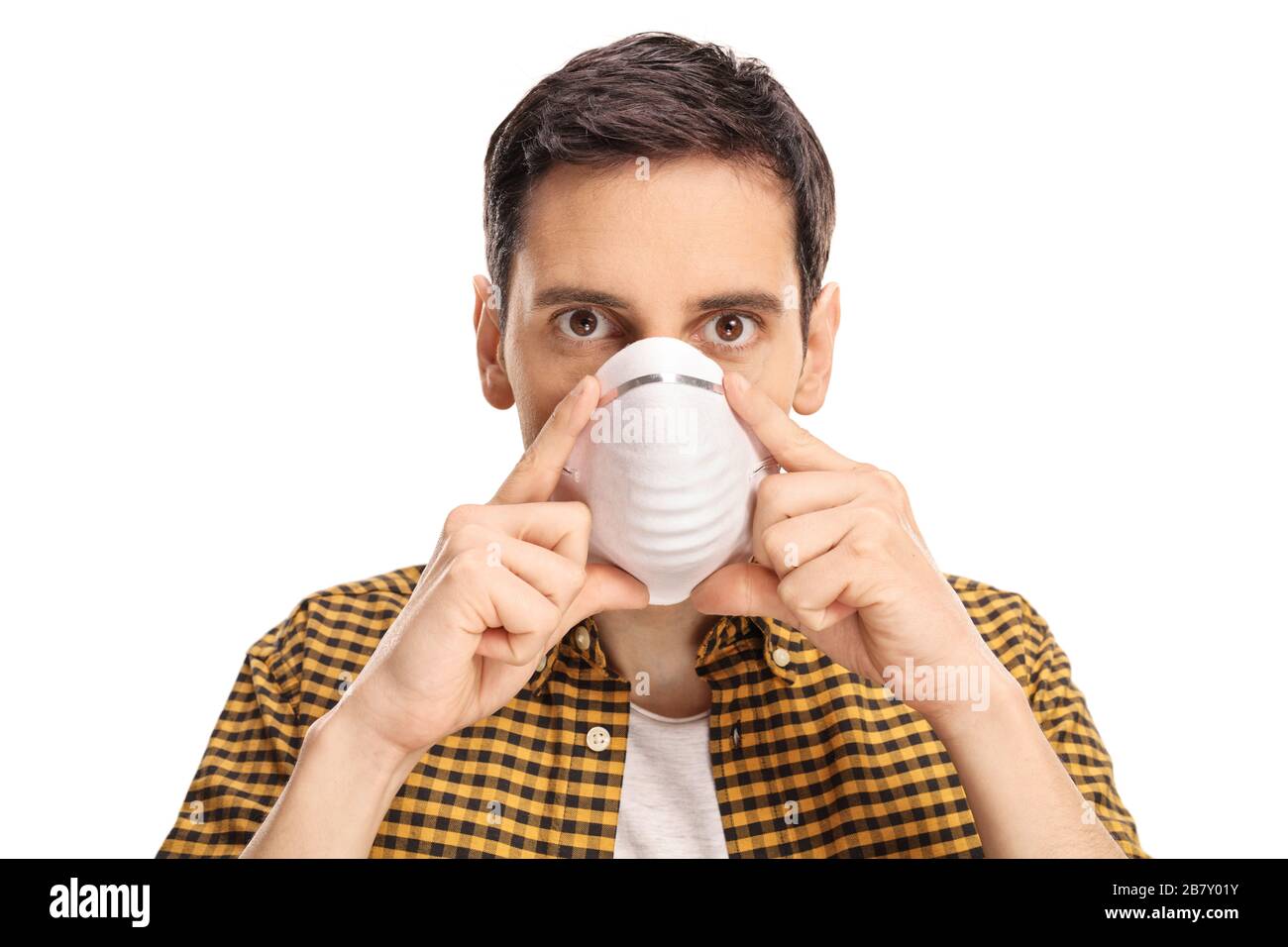 Portrait of a young man holding a protection mask over mouth and nose ...