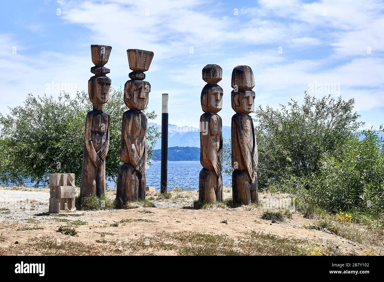 Four totem poles by lake Nahuel Huapi, Barilche Stock Photo - Alamy
