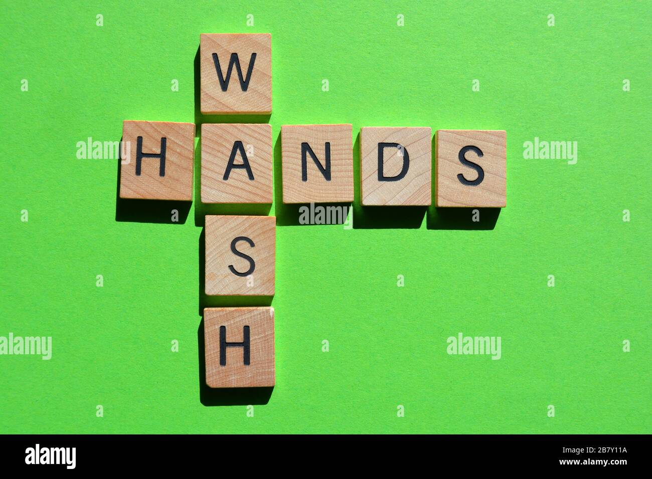 Wash Hands, words in 3d wooden alphabet letters on green background ...