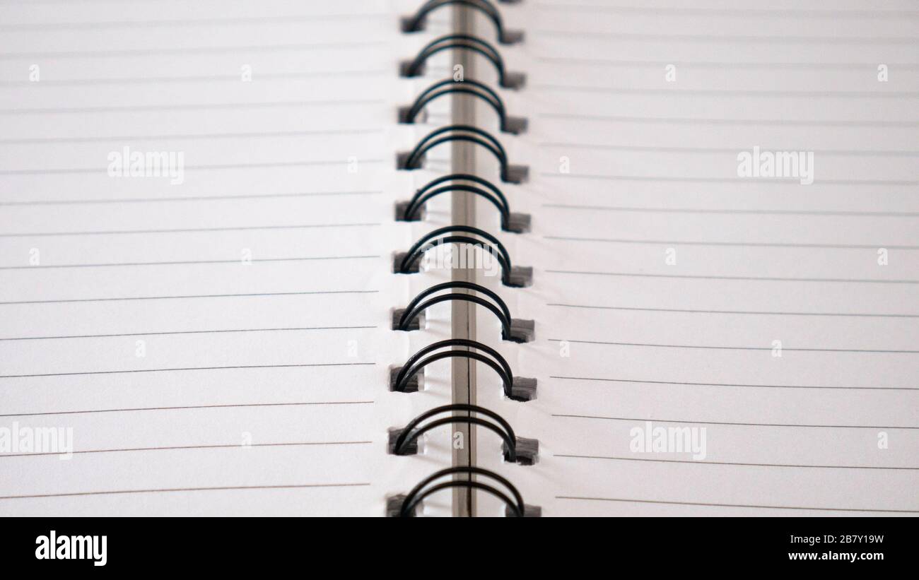 Close up top view of lines notebook or spiral notepad paper background ...