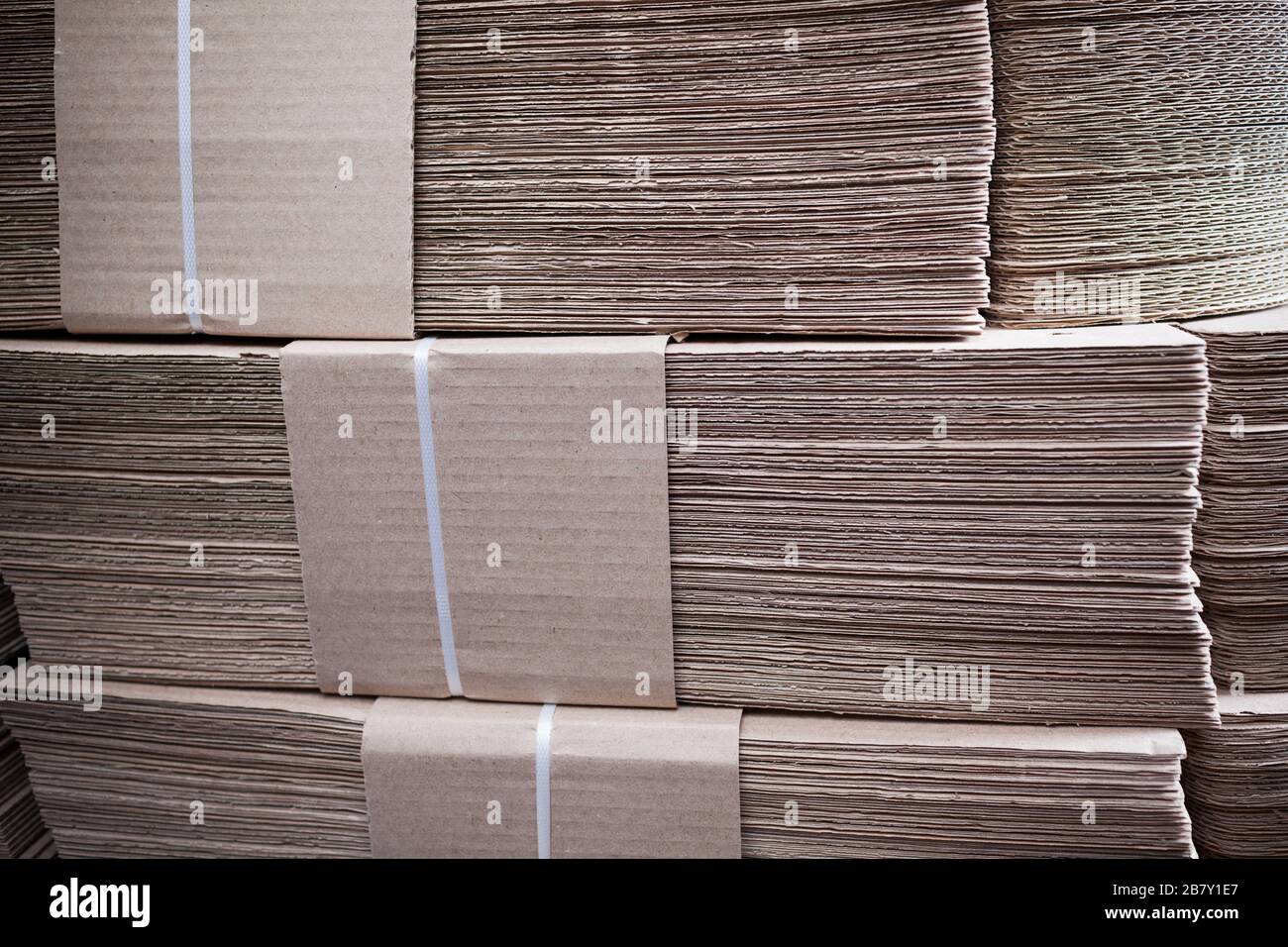 Close-up large cardboard piles lie on top of each other in a warehouse ...