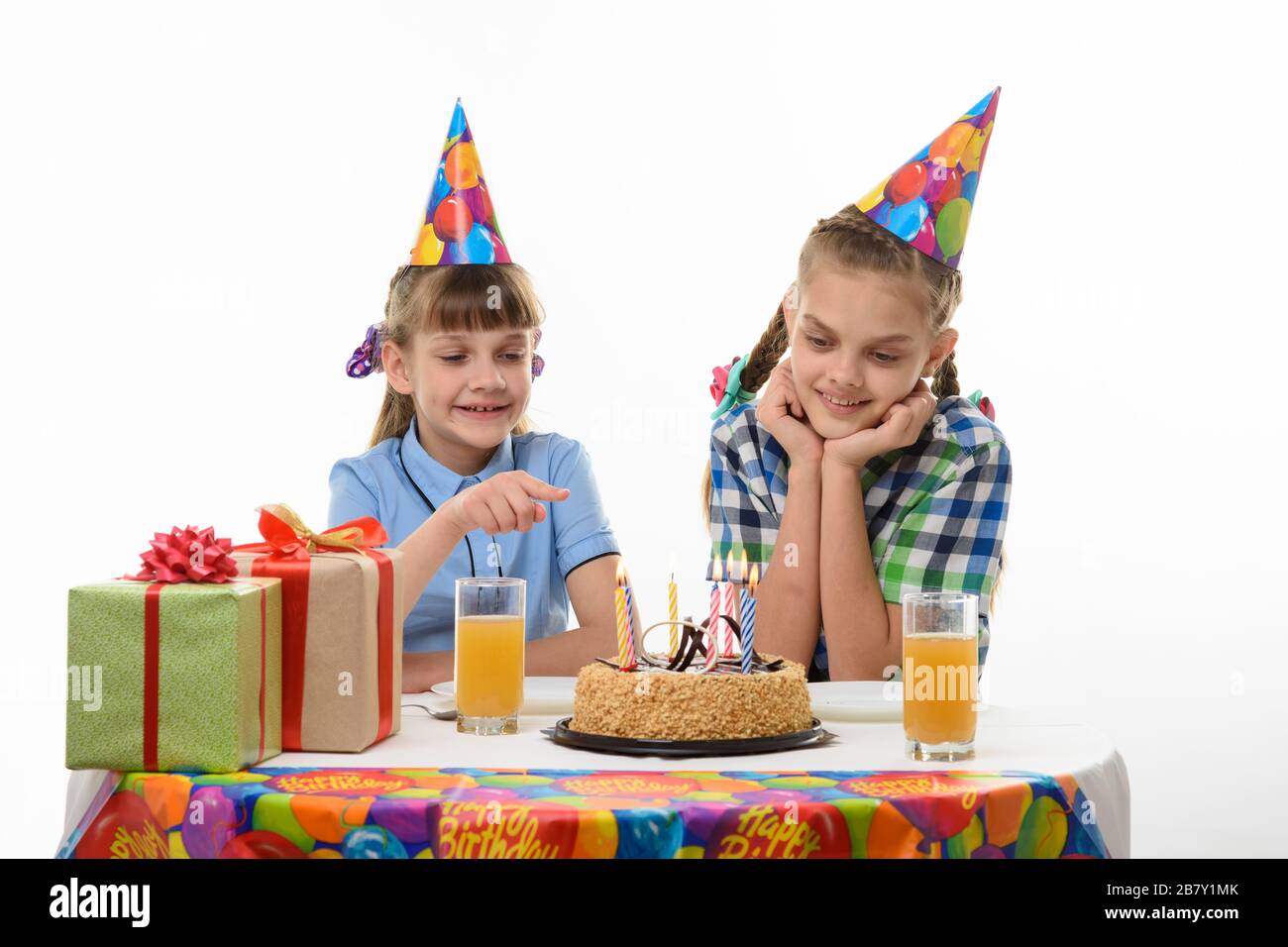 Two girls on a birthday count candles Stock Photo - Alamy